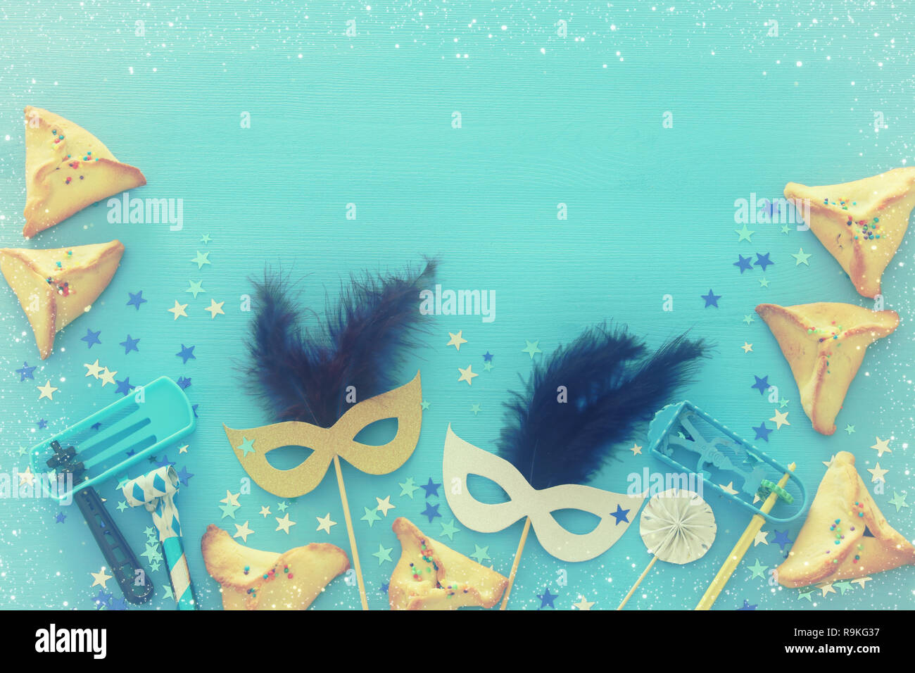 Purim celebration concept (jewish carnival holiday) over blue wooden ...