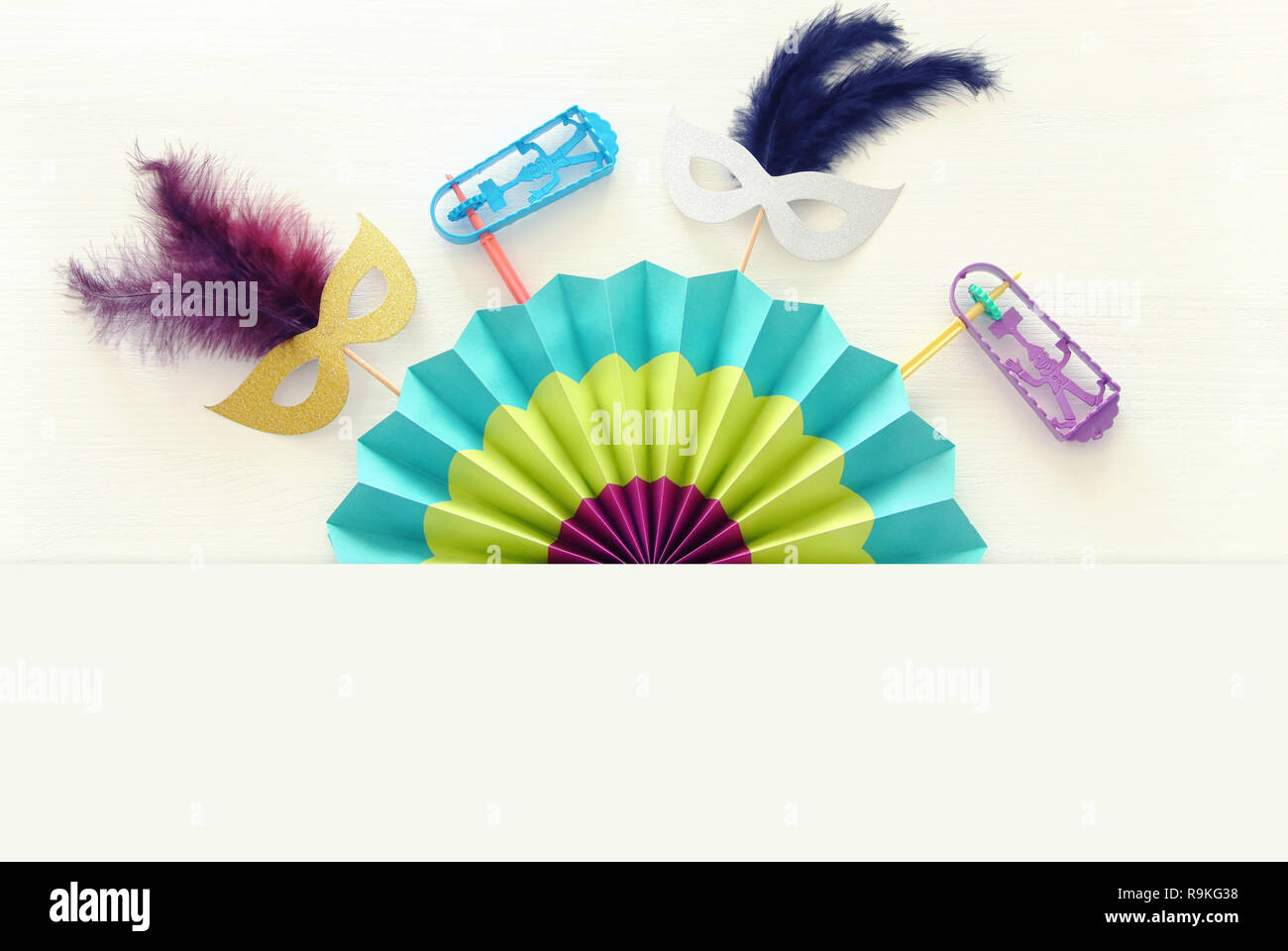 Purim celebration concept (jewish carnival holiday) over white wooden ...