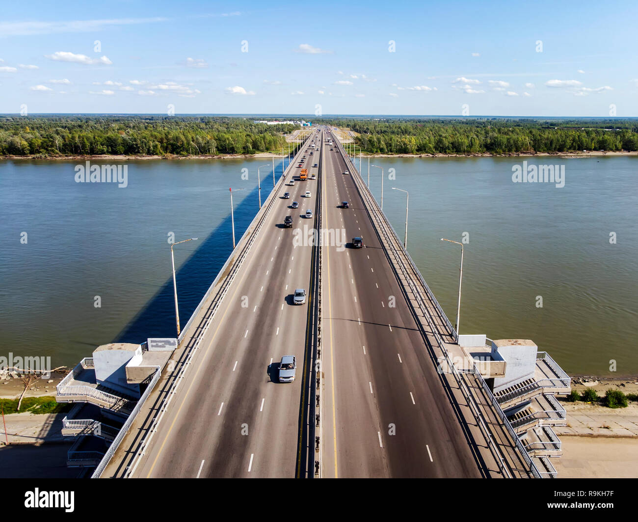 A view to the well-built city bridge across the river. City river gates ...