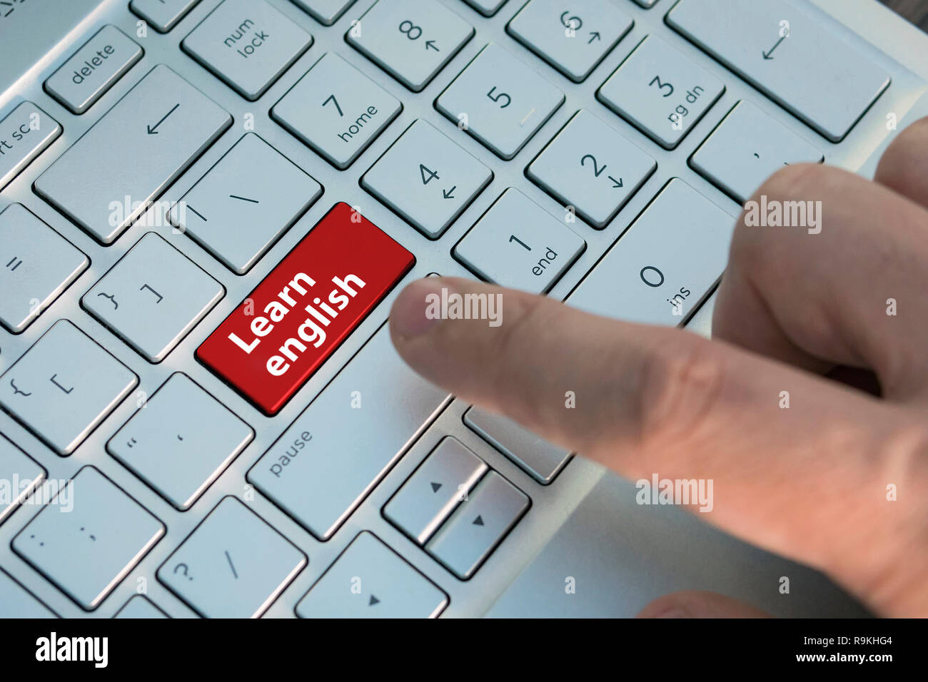 Closed up finger on keyboard with word LEARN ENGLISH. , Red button ...
