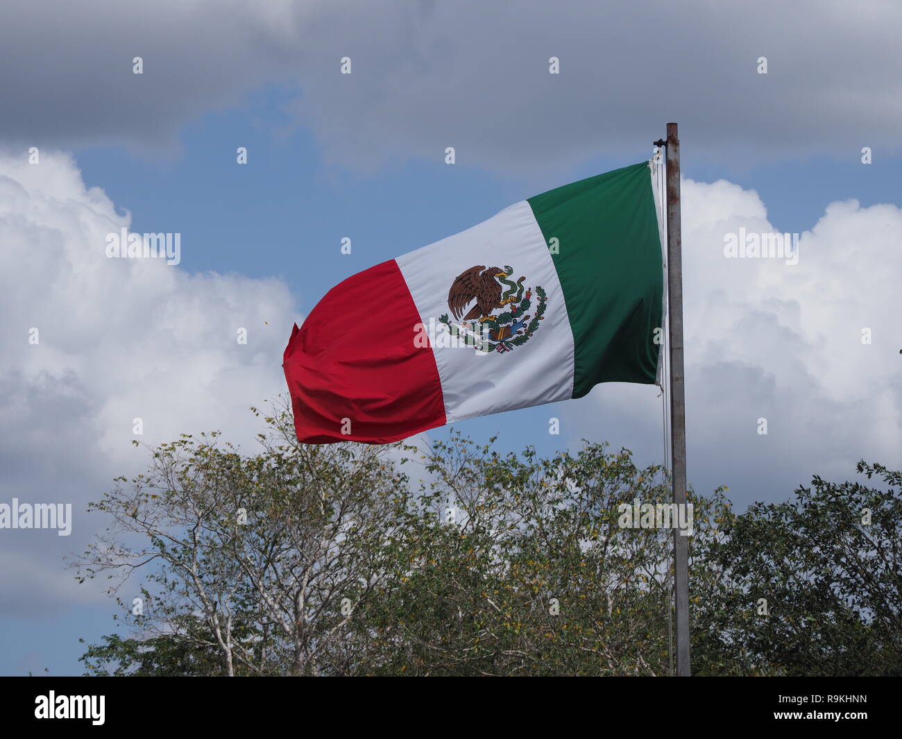 National maxican flag at Chichen Itza city near archaeological site in ...