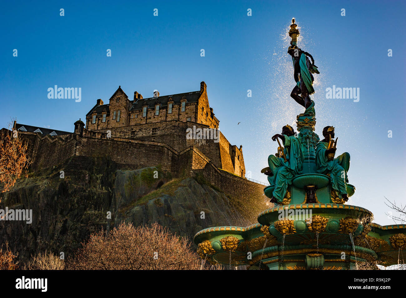 Ross fountain lit by golden sunset light at the foot of the Castle Rock ...