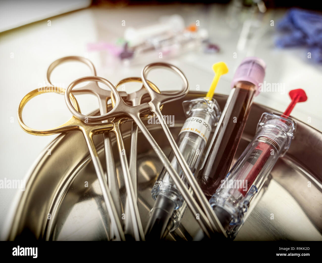 Syringes and scissors of suture in a tray metal, conceptual image Stock ...