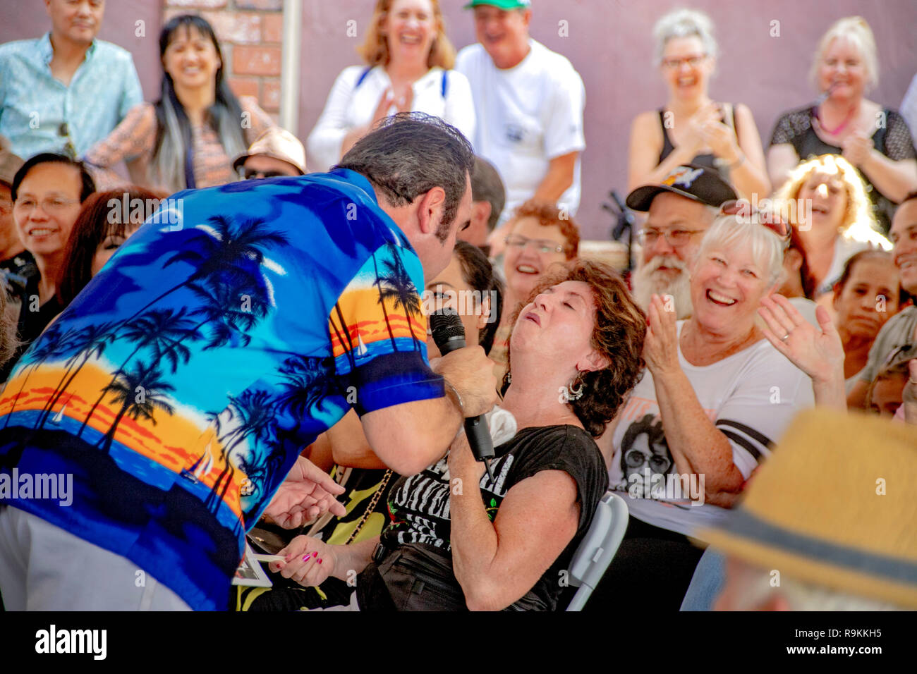 Performing rock 'n' roll classic songs, an enthusiastic singer charms ...