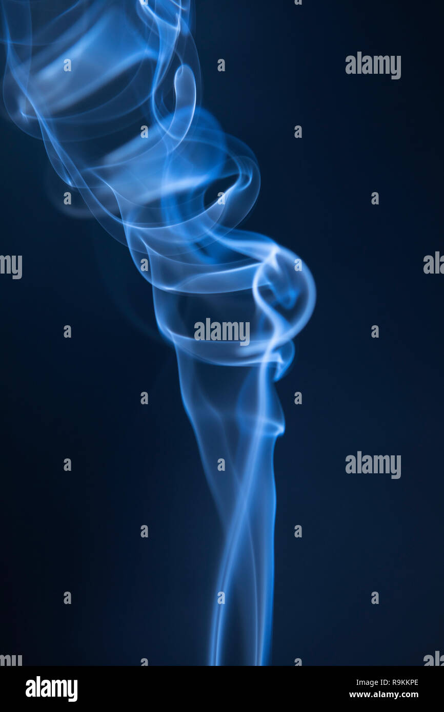 Abstract blue smoke swirls on dark background Stock Photo - Alamy