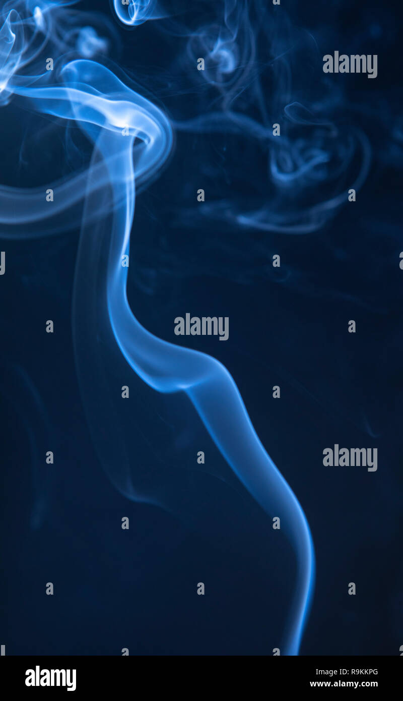 Abstract blue smoke swirls on dark background Stock Photo - Alamy