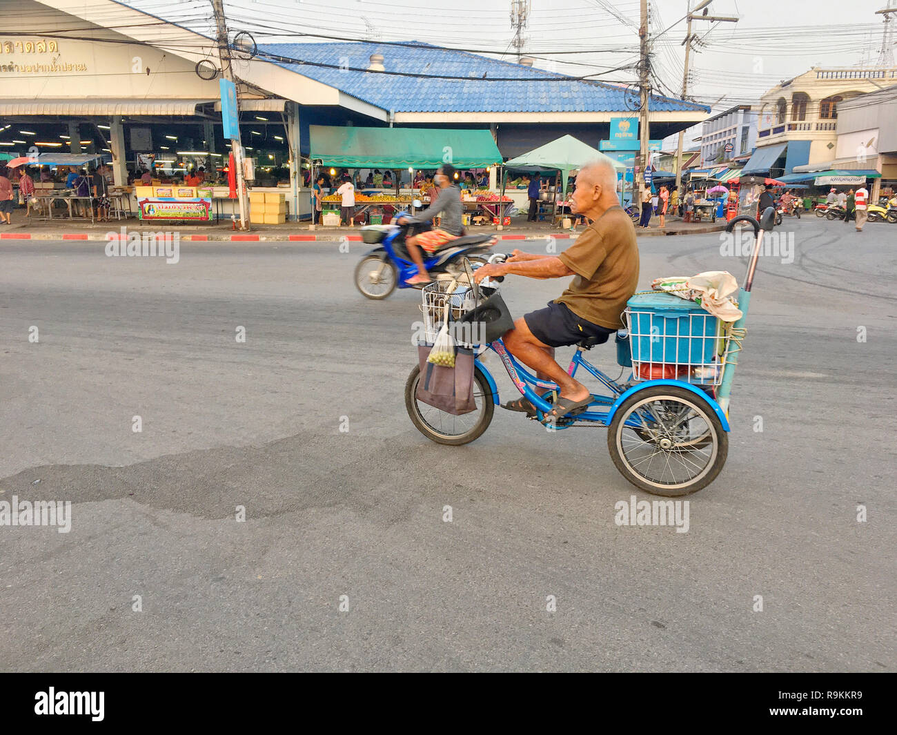 Photo of An old man driving his custome blue tricycle on the street of ...