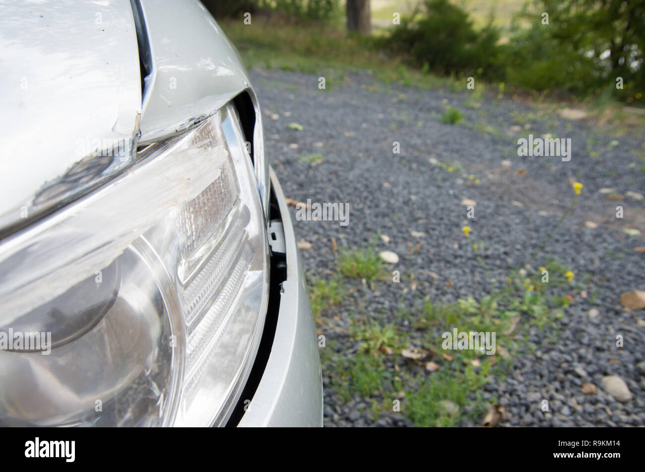 Damaged car headlight and panels after a collision in wet weather Stock ...