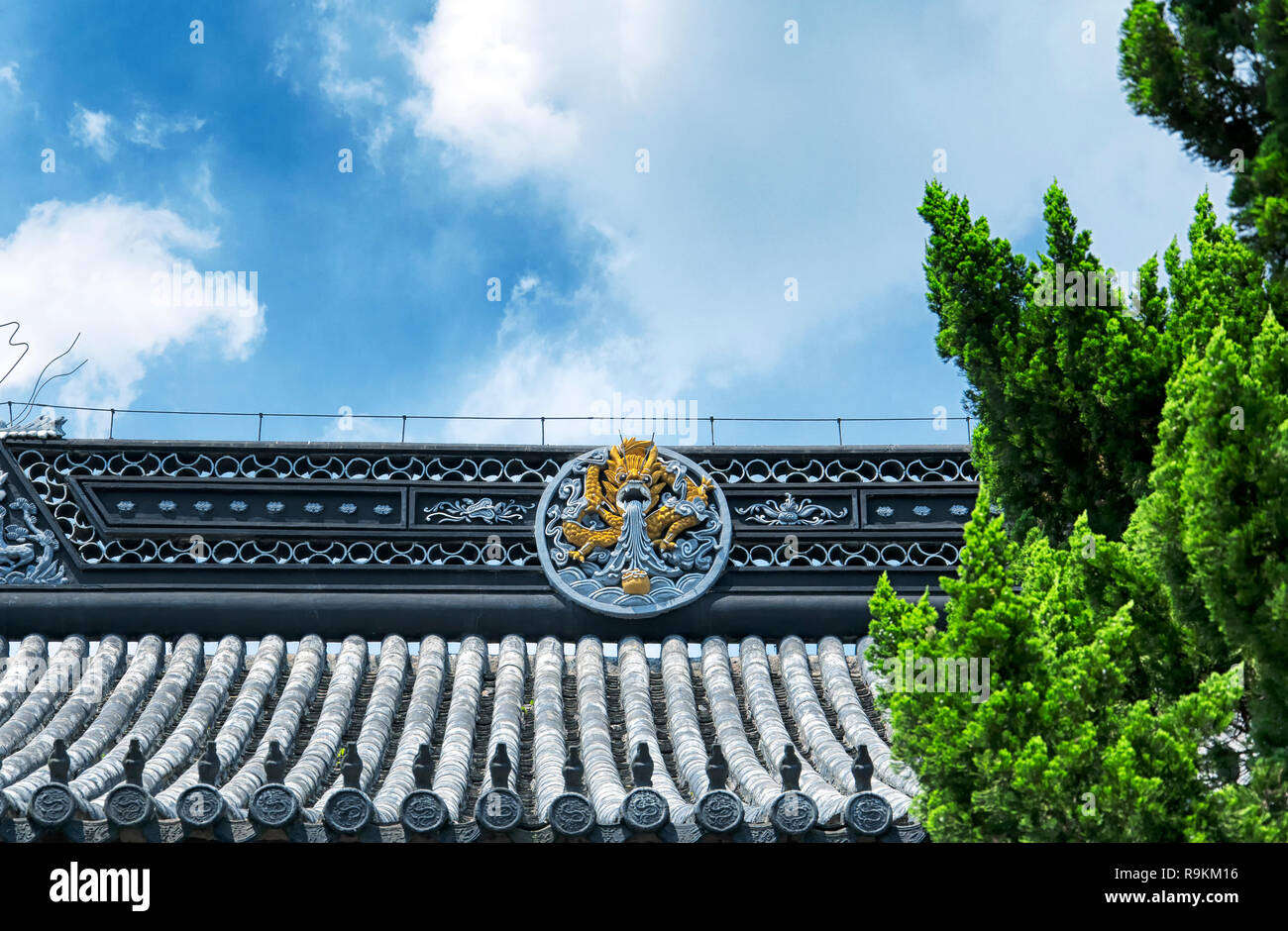 A dragon carving on the roof of Baosheng Temple in Luzhi ancient town ...