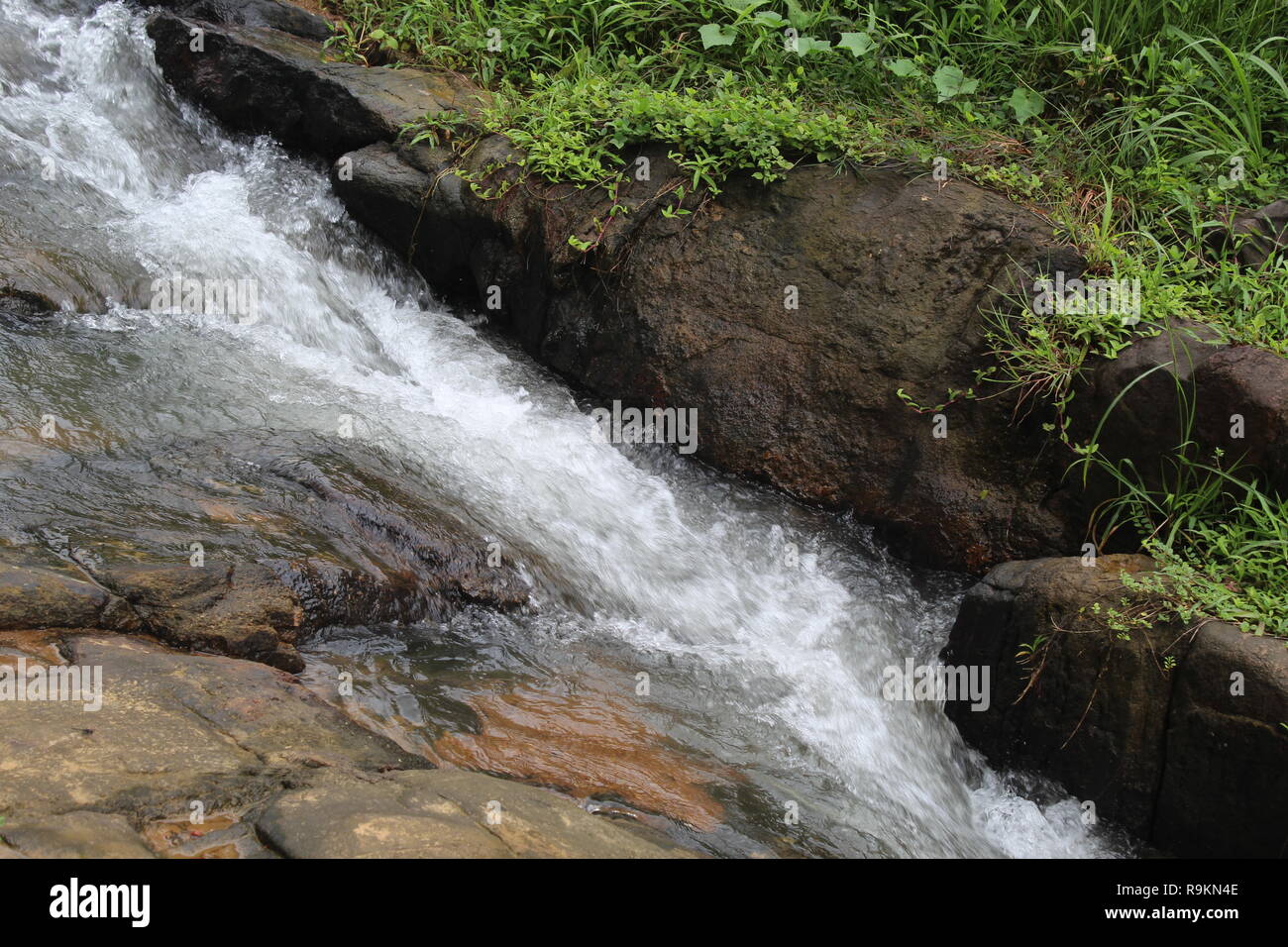 Water flowing on a hill very fast during a flood in South India ...