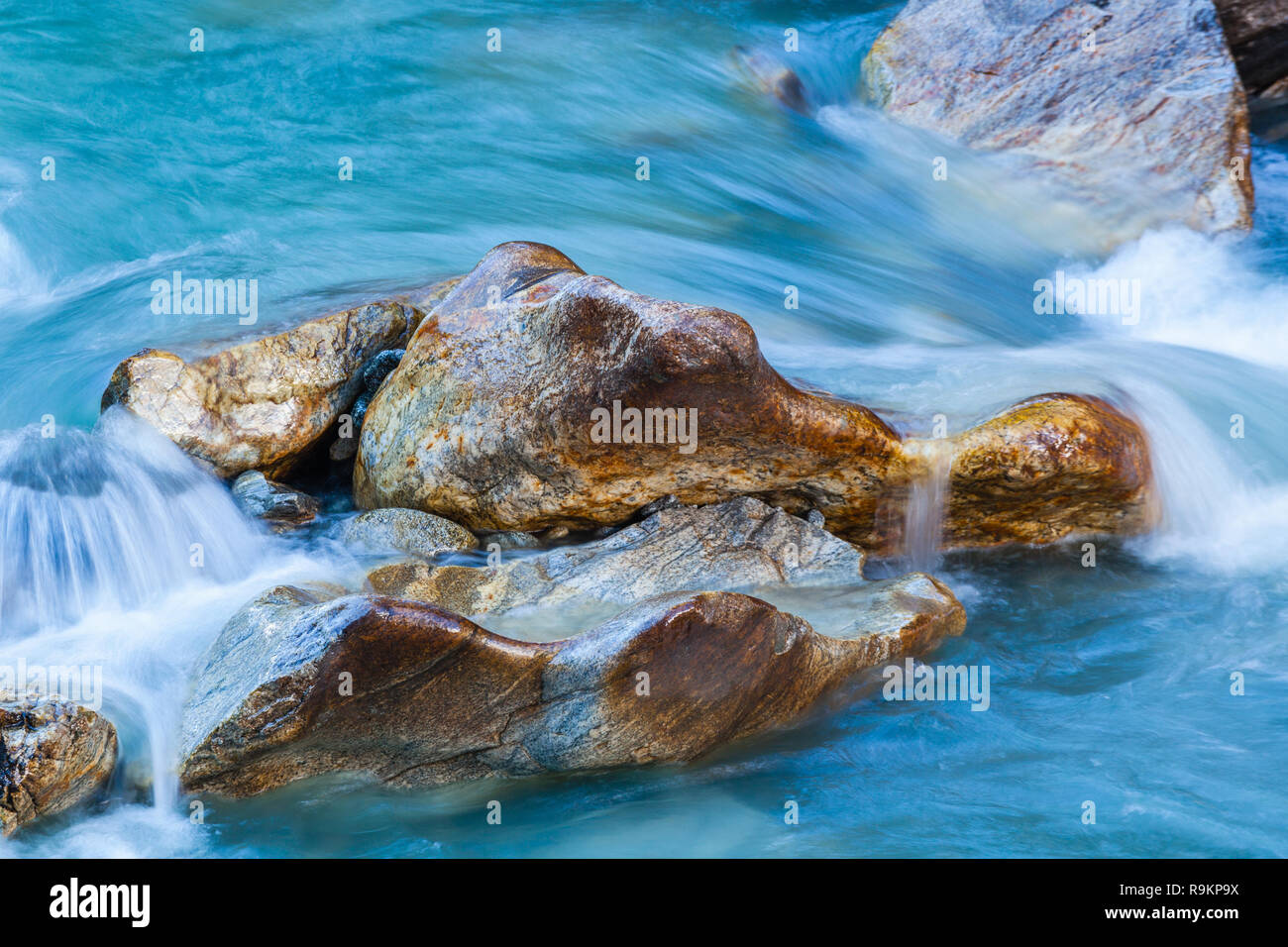 Rocks in flowing river Stock Photo - Alamy