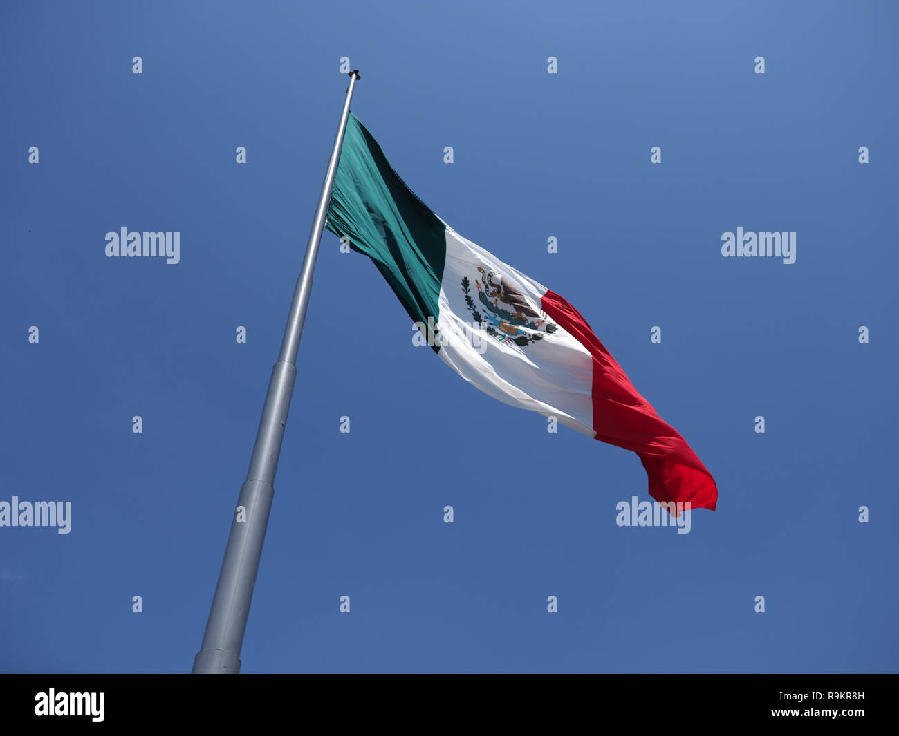 National maxican flag on beach at bay of Pacific Ocean in Acapulco city ...