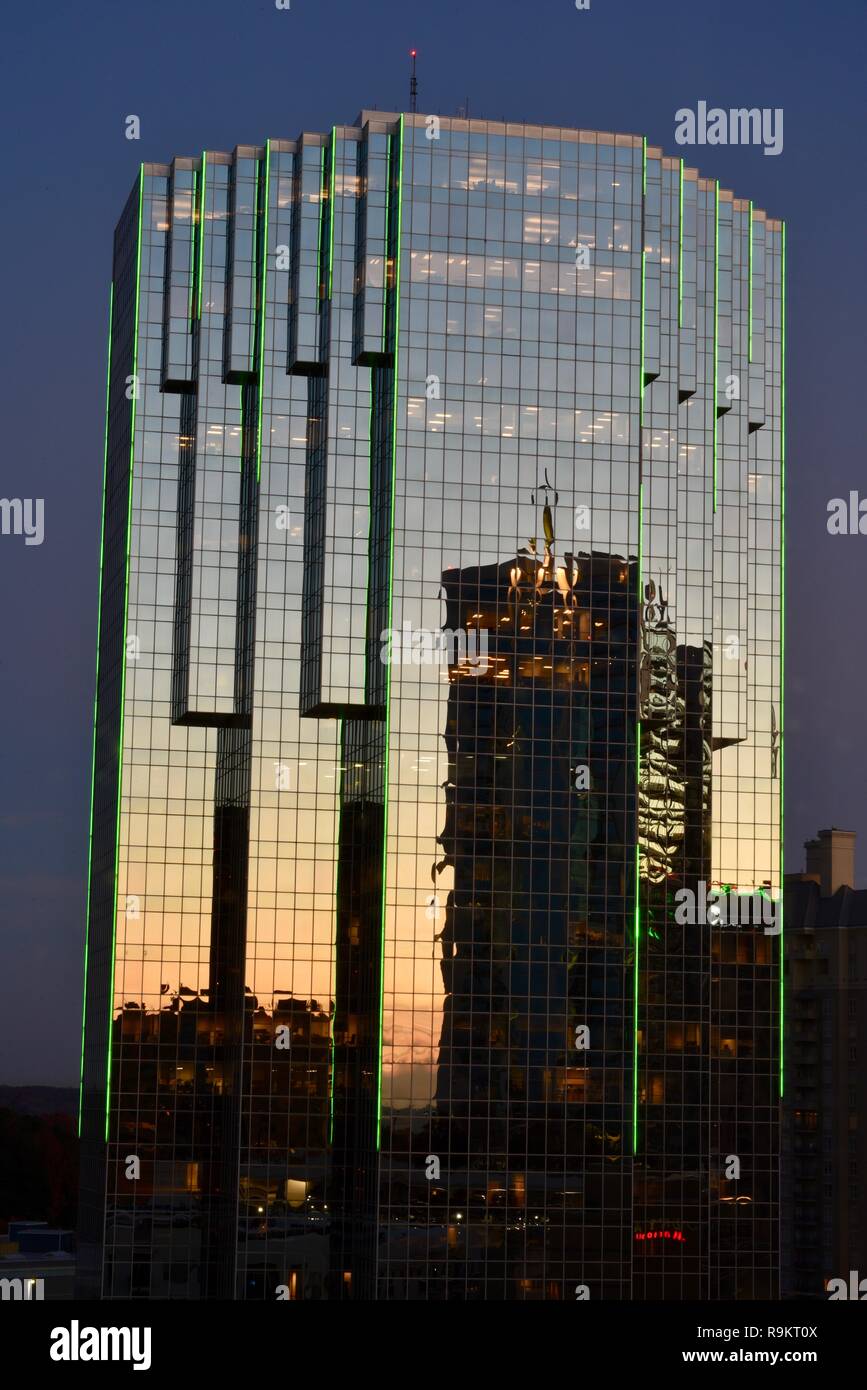 Sunrise reflections off modern, glass skyscraper buildings in upscale ...