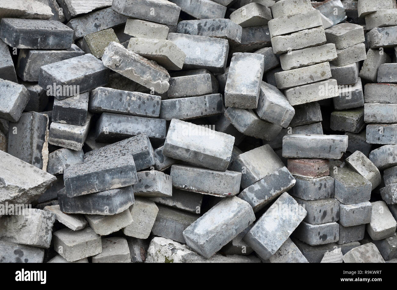 A large pile of disassembled paving slabs. A lot of square stones ...