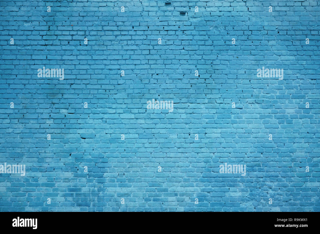 The texture of the brick wall of many rows of bricks painted in blue ...