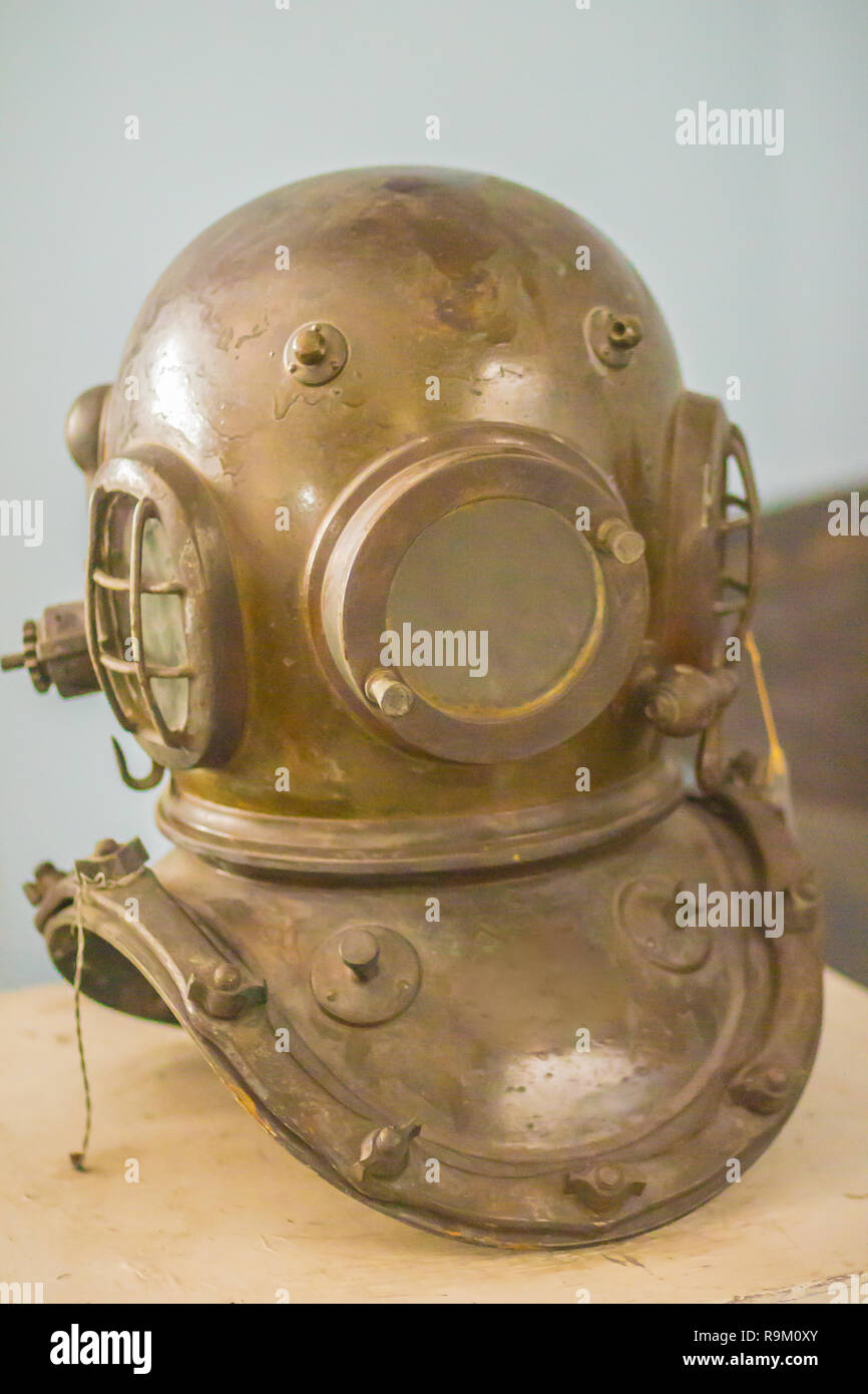 Antique metal scuba helmet, heavy diving equipment with air supply ...