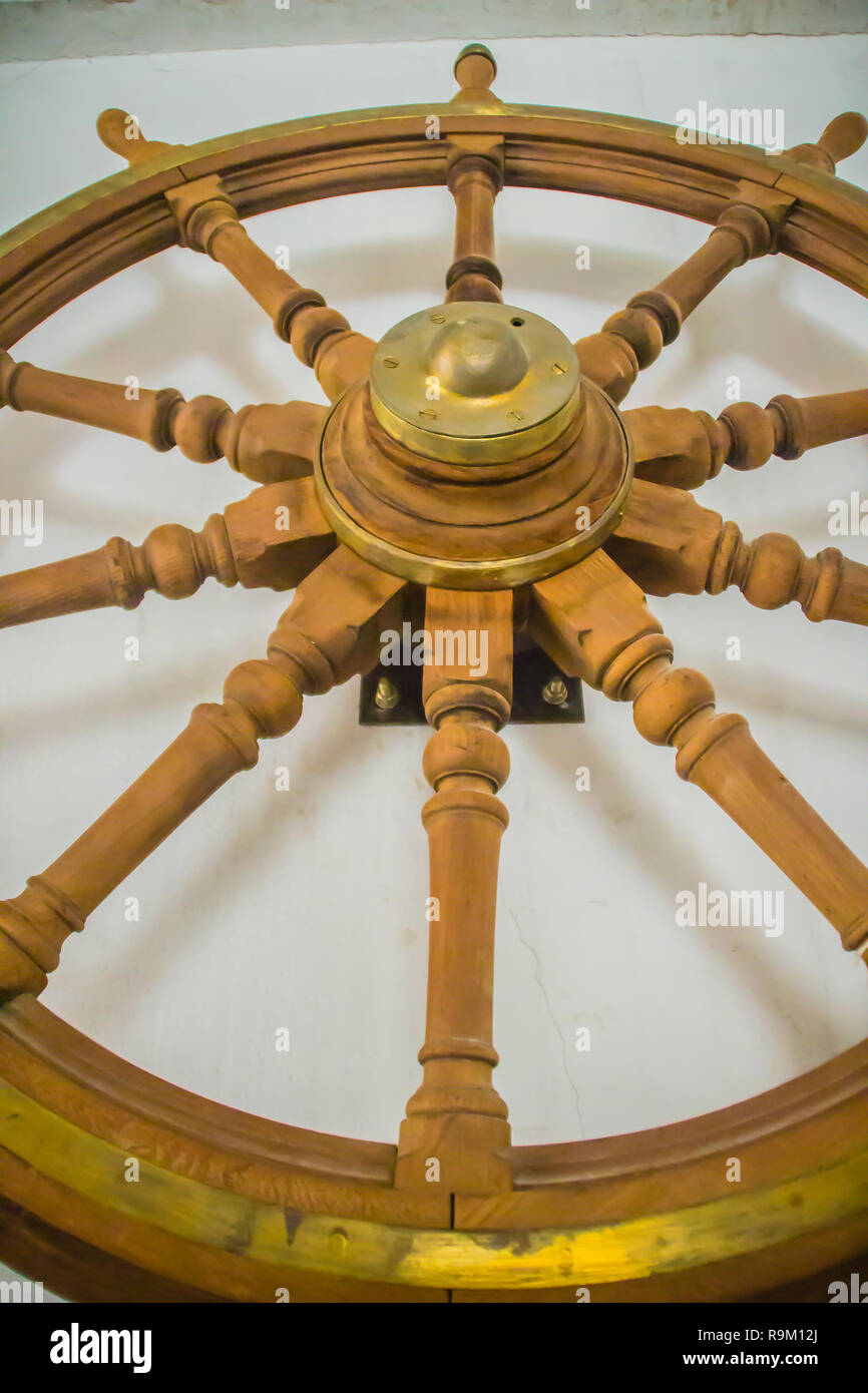 Vintage old wooden ship steering wheel in the public naval museum ...