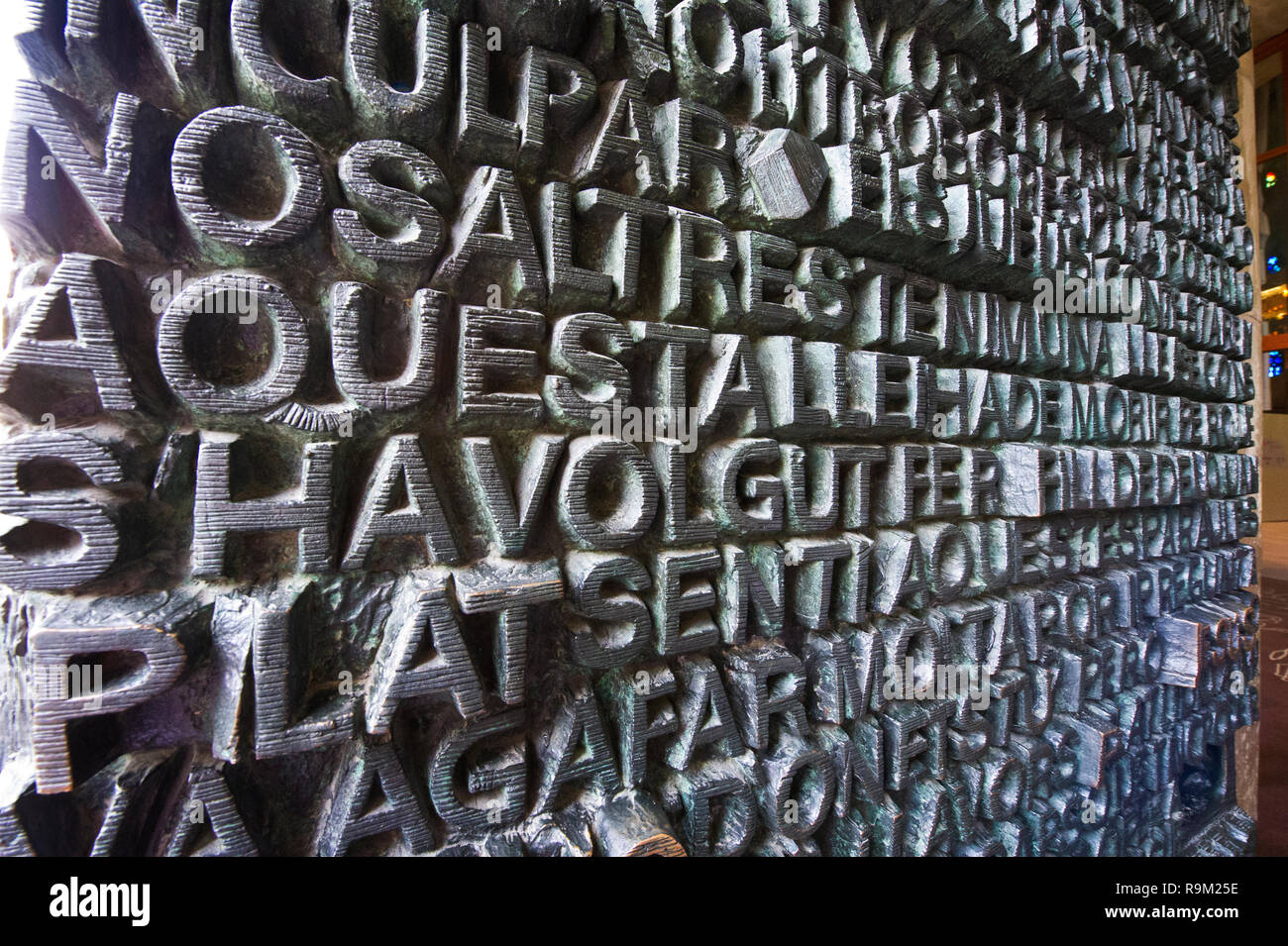 Carved words on the main wooden door of the Sagrada Familia designed by ...