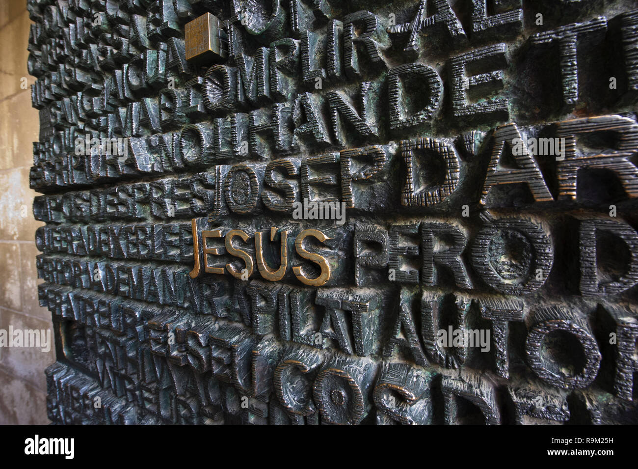Carved words on the main wooden door of the Sagrada Familia designed by ...