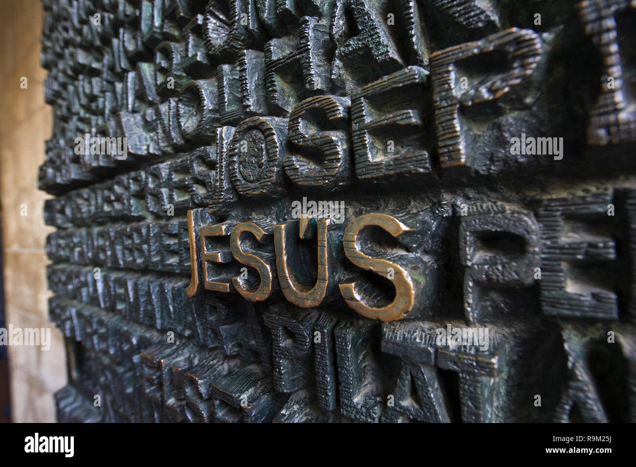 Carved words on the main wooden door of the Sagrada Familia designed by ...