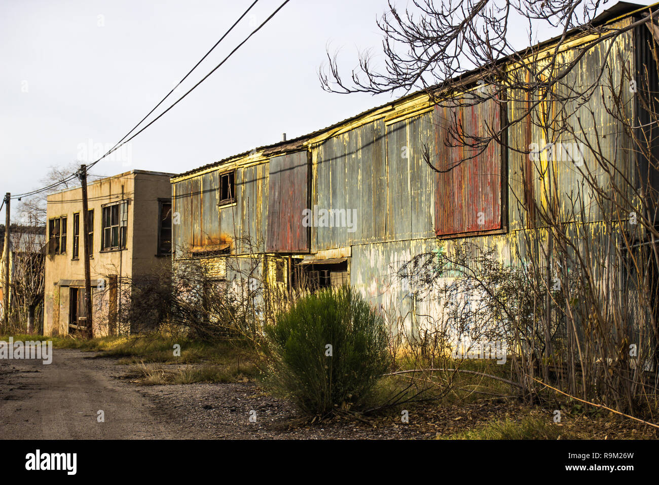 Rear Of Boarded Up Metal Buildings In Depressed Area Stock Photo - Alamy