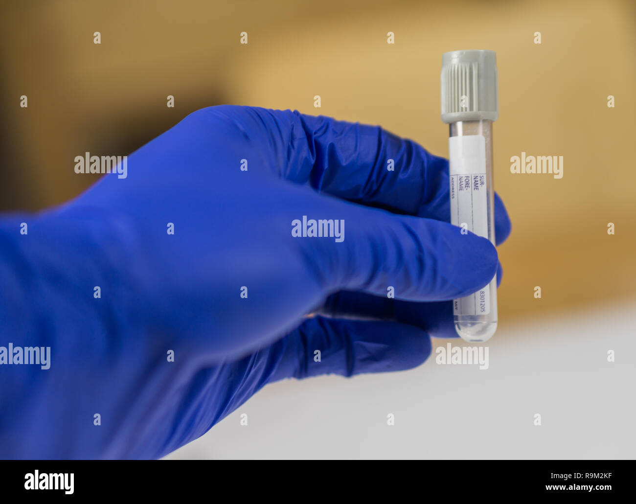 Hand glove holding glass bottle hi-res stock photography and images - Alamy
