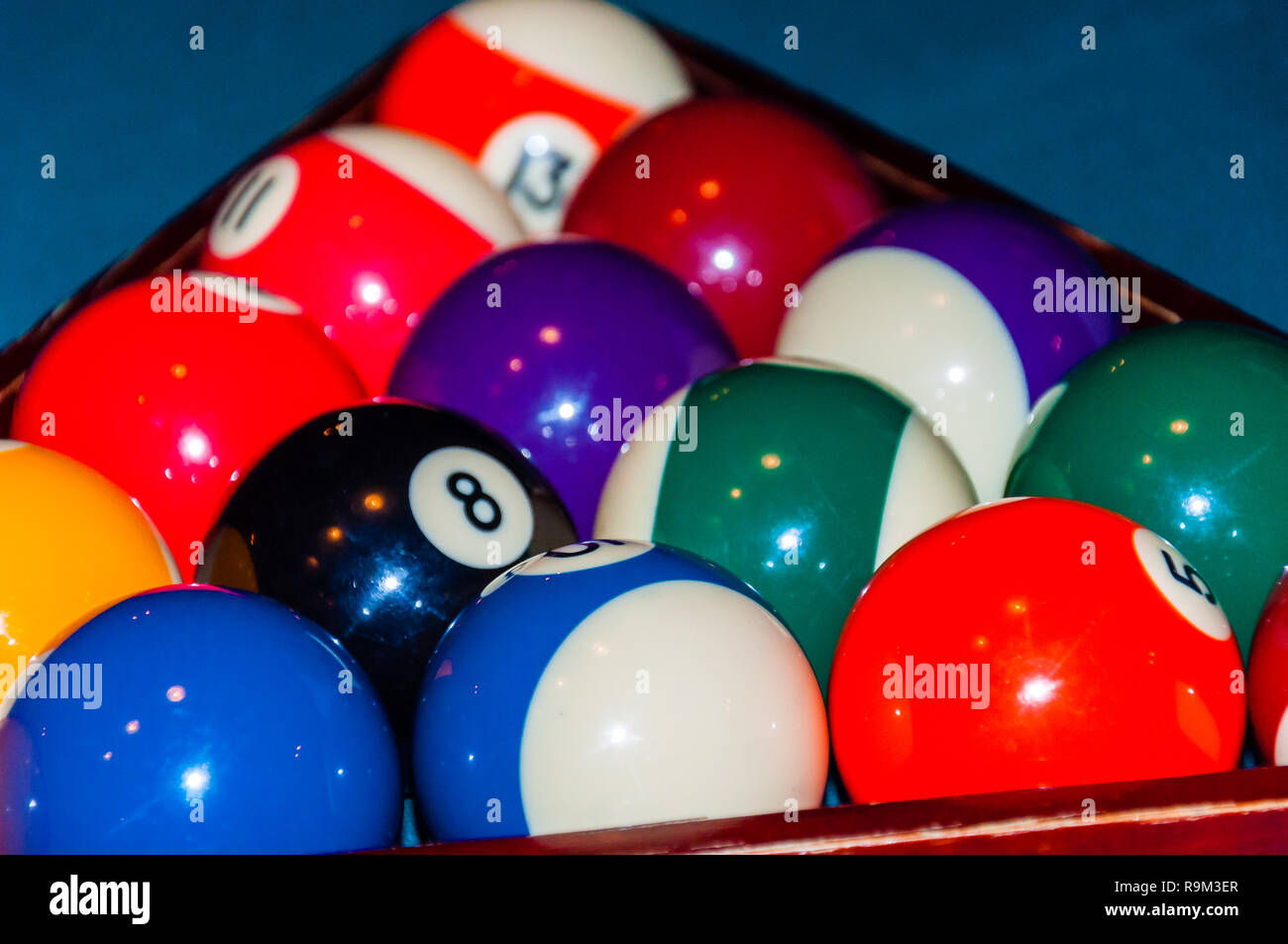 Pool game balls set in triangle on the blue table Stock Photo - Alamy