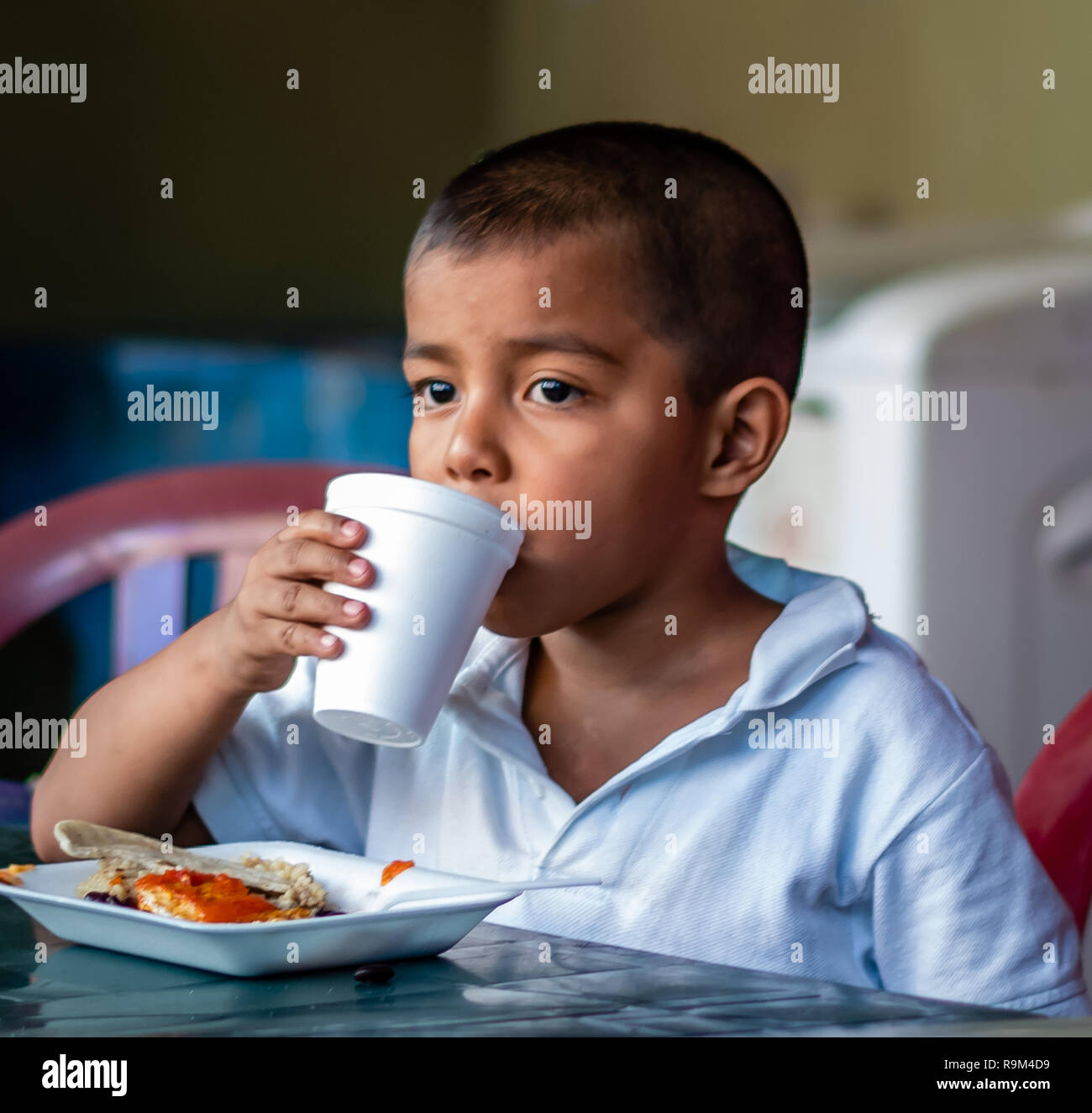 Guatemalan child drinking water Stock Photo - Alamy