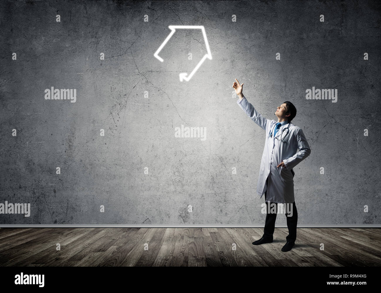 Doctor with house symbol Stock Photo - Alamy