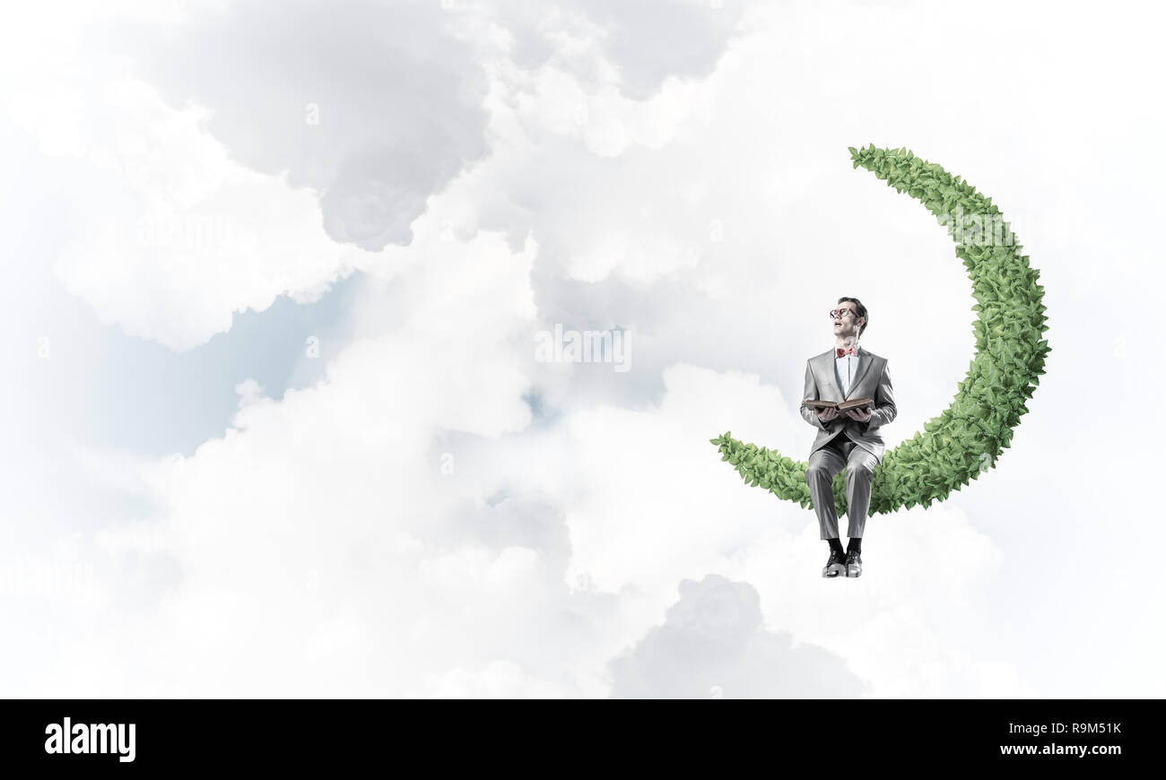Young businessman or student on moon in sky studying the science Stock ...