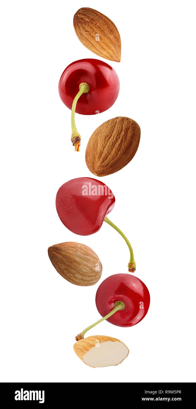 Isolated falling fruits. Flying cherry and almonds isolated on white ...