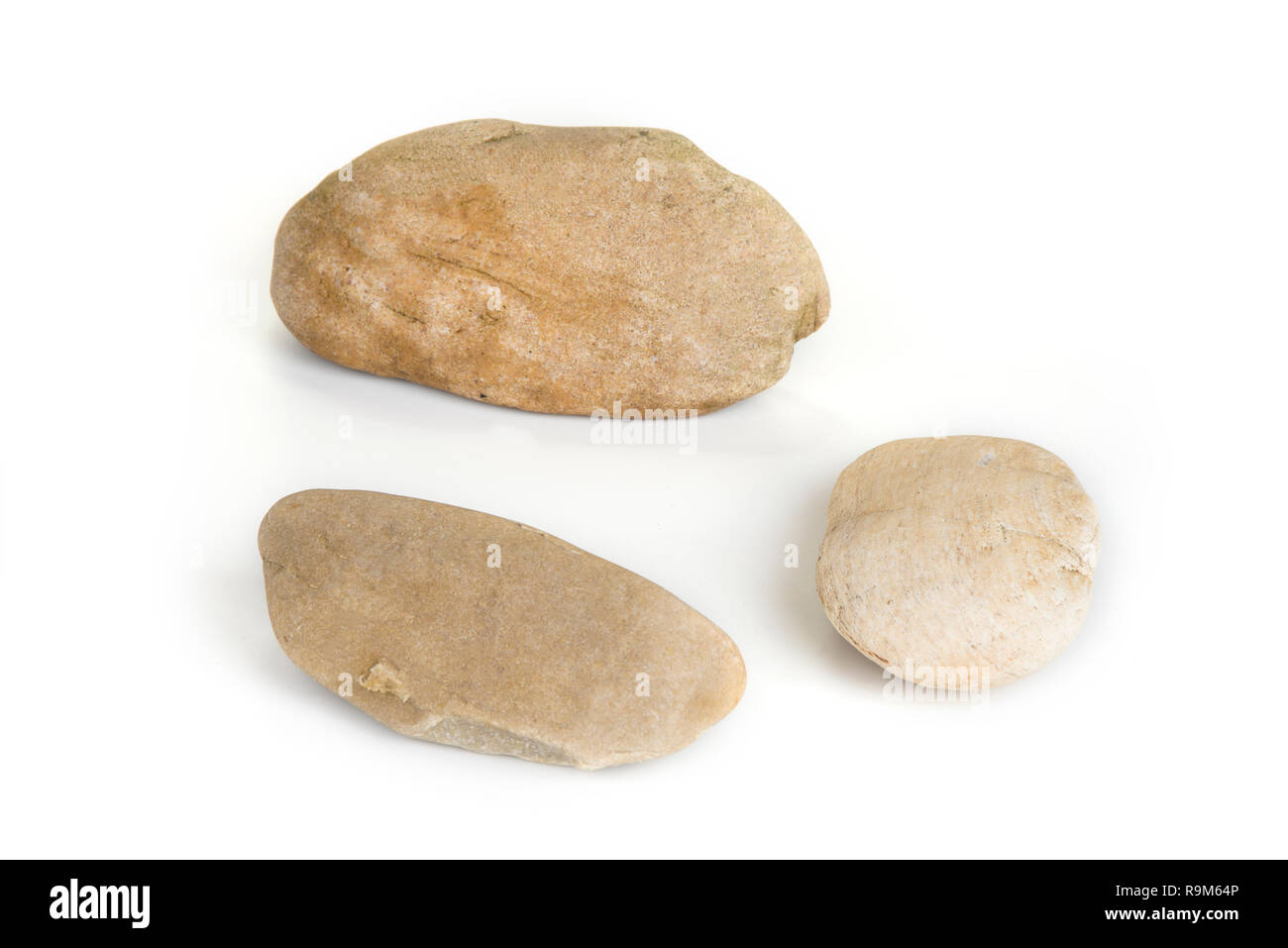 Three pebble stones on a white background Stock Photo - Alamy