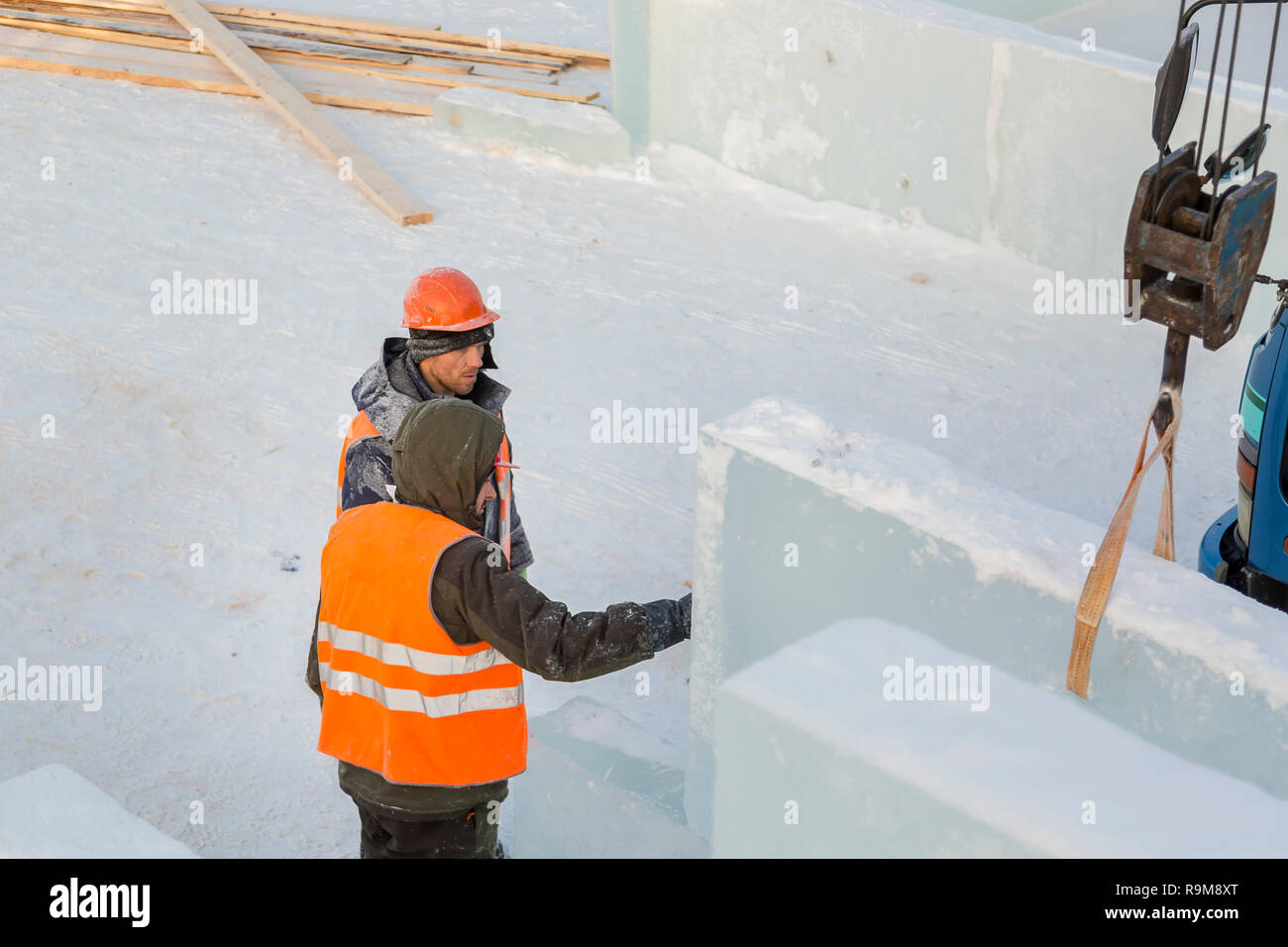 Workers at the construction site of the ice town for a conversation ...