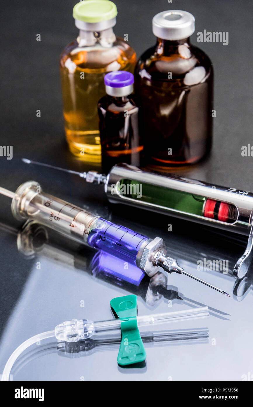 Several vials and syringe in laboratory, conceptual image Stock Photo - Alamy