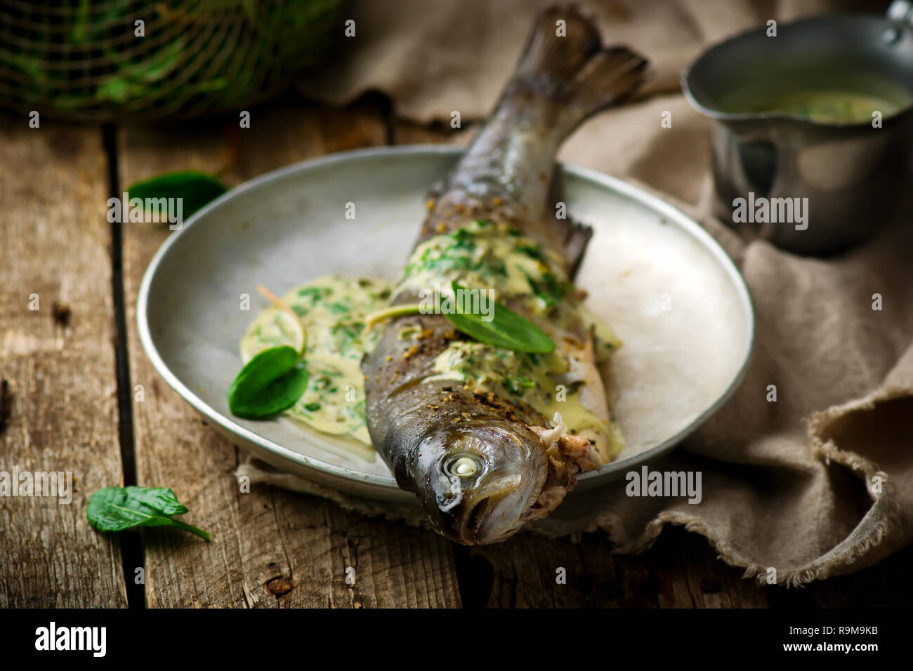 trout stewed with sauce from a sorrel. Selective focus.Style rustic ...