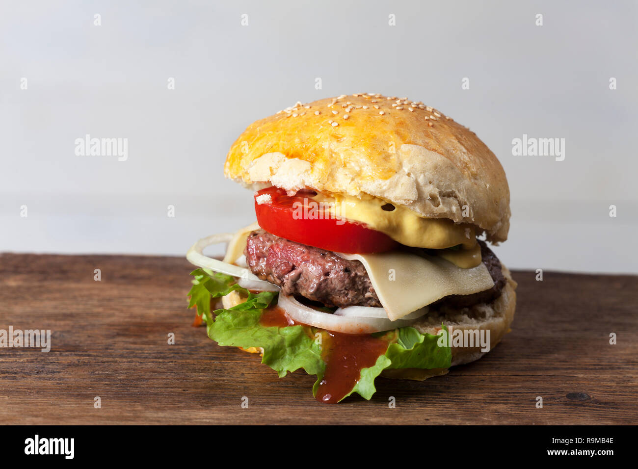home made hamburger on rustic wood Stock Photo - Alamy