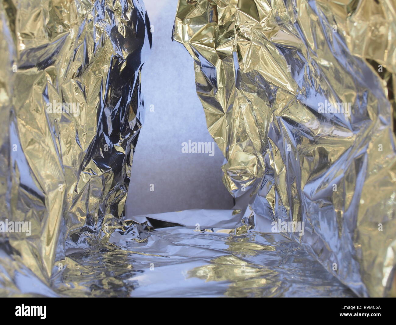 Passage between two rocks. Fantastic landscape of crumpled aluminum ...