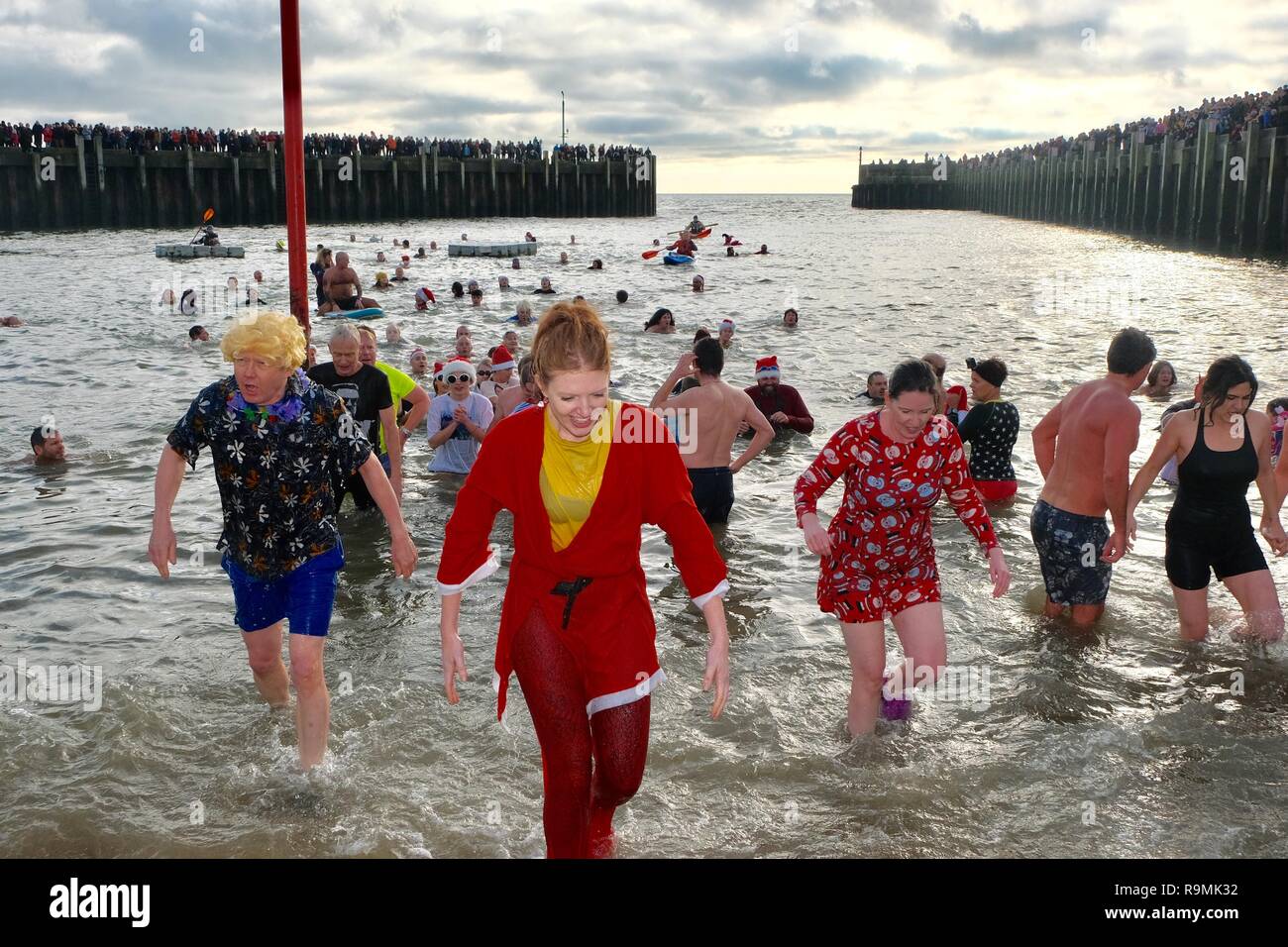 West Bay, Dorset, UK. 26th December 2018.Hundreds of swimmers, many in ...