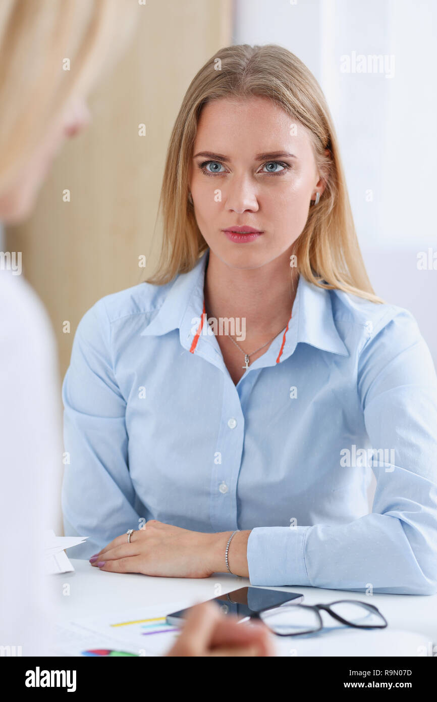 Portrait of serious businesswoman sitting at desk Stock Photo - Alamy