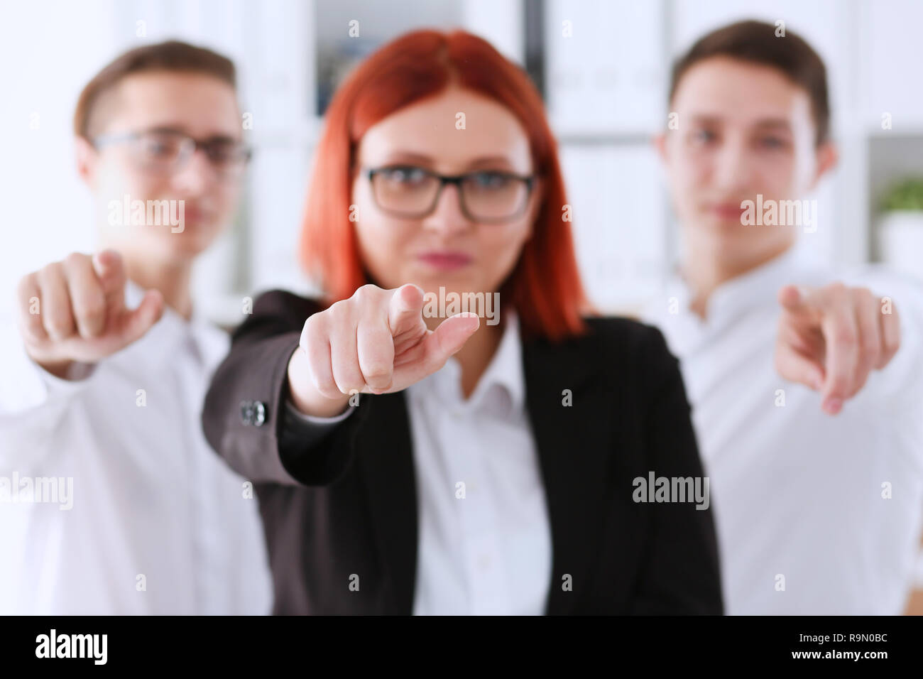 A group of business people pointing their Stock Photo - Alamy