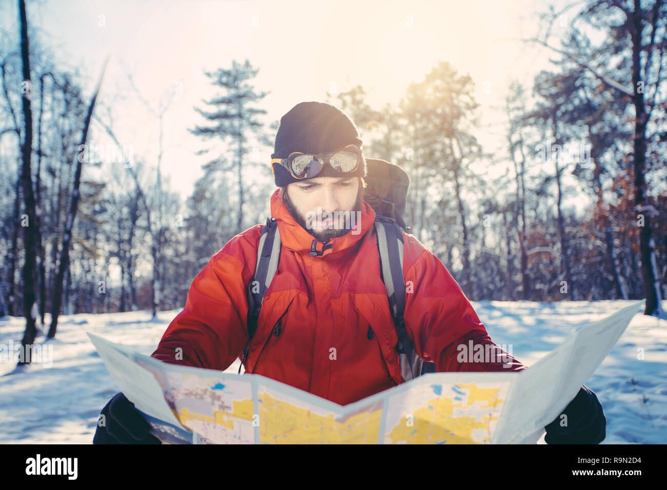 Hiker checks map for direction Stock Photo - Alamy