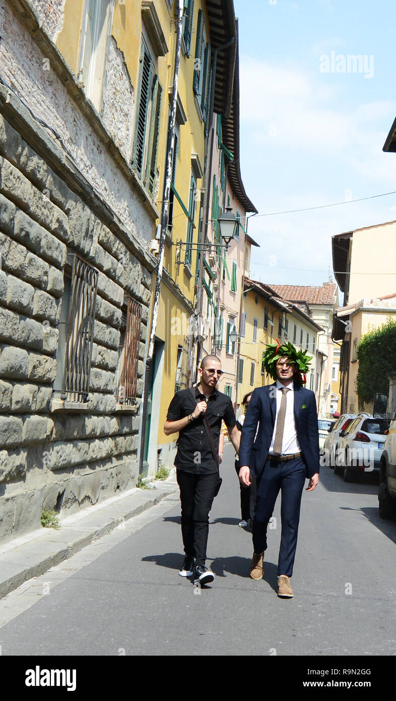 A University of Pisa graduate walking back from the graduation ceremony ...