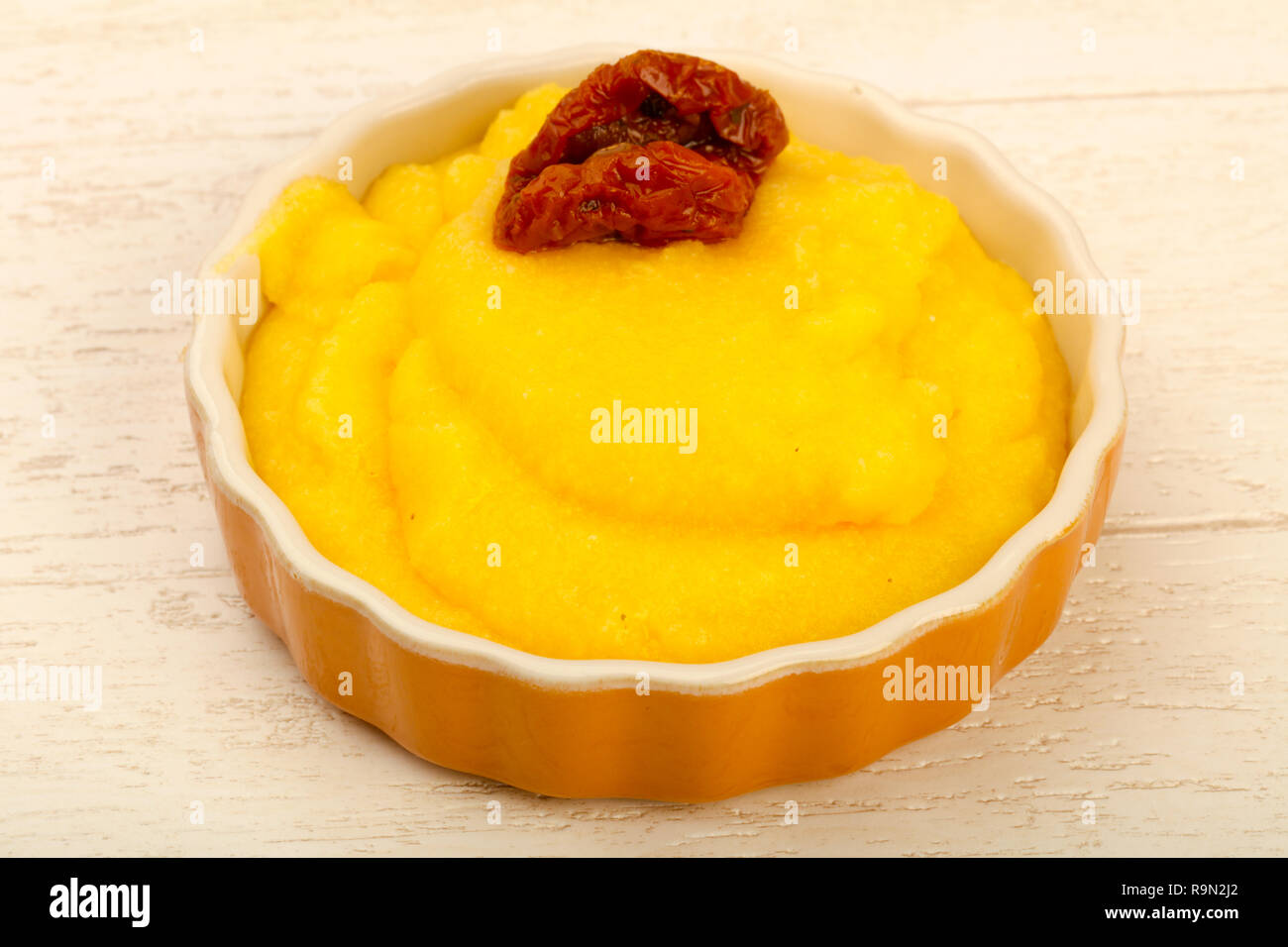 Polenta with dry tomato Stock Photo - Alamy