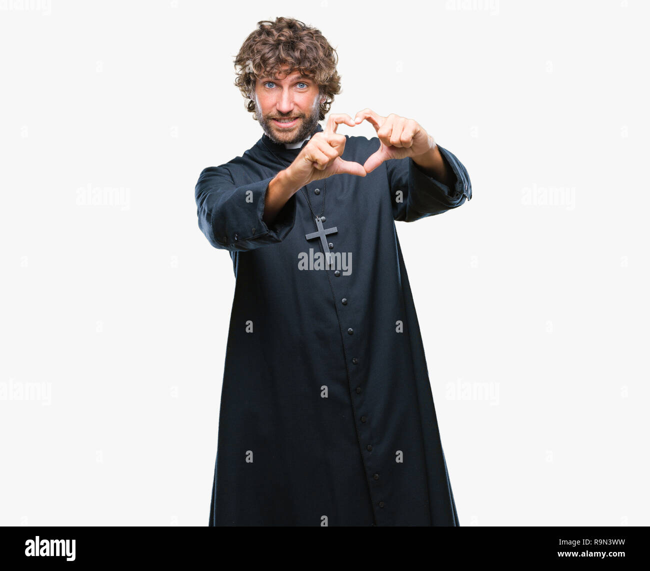 Handsome hispanic catholic priest man over isolated background smiling ...