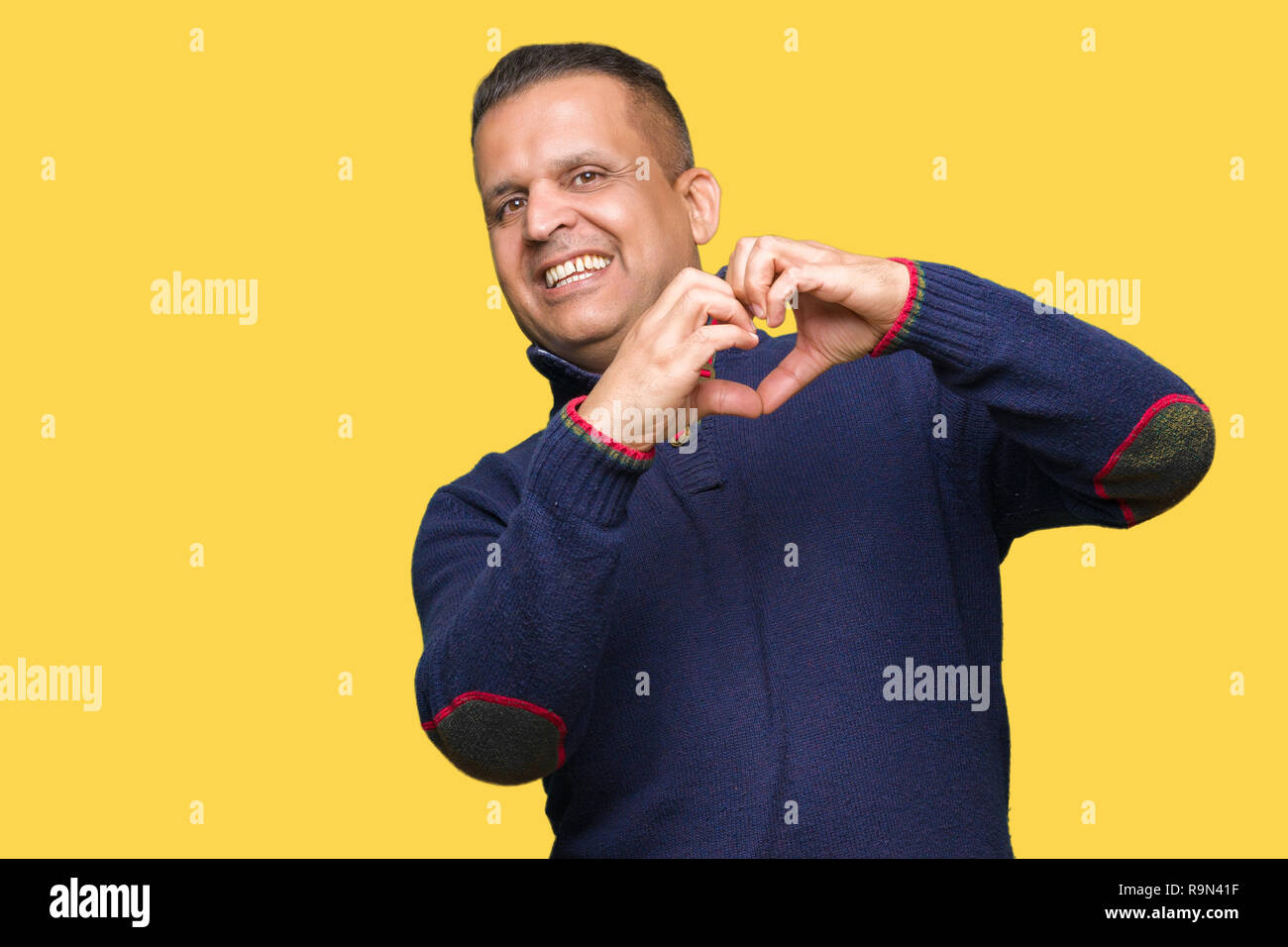 Middle age arab man over isolated background smiling in love showing ...