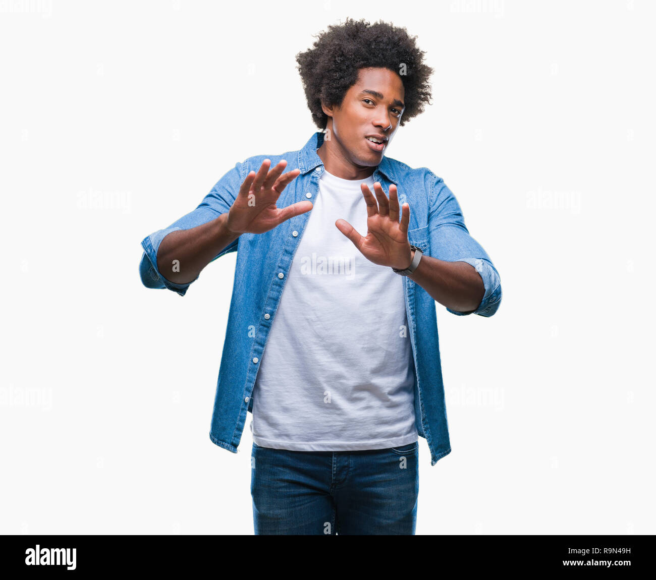 Afro american man over isolated background afraid and terrified with ...