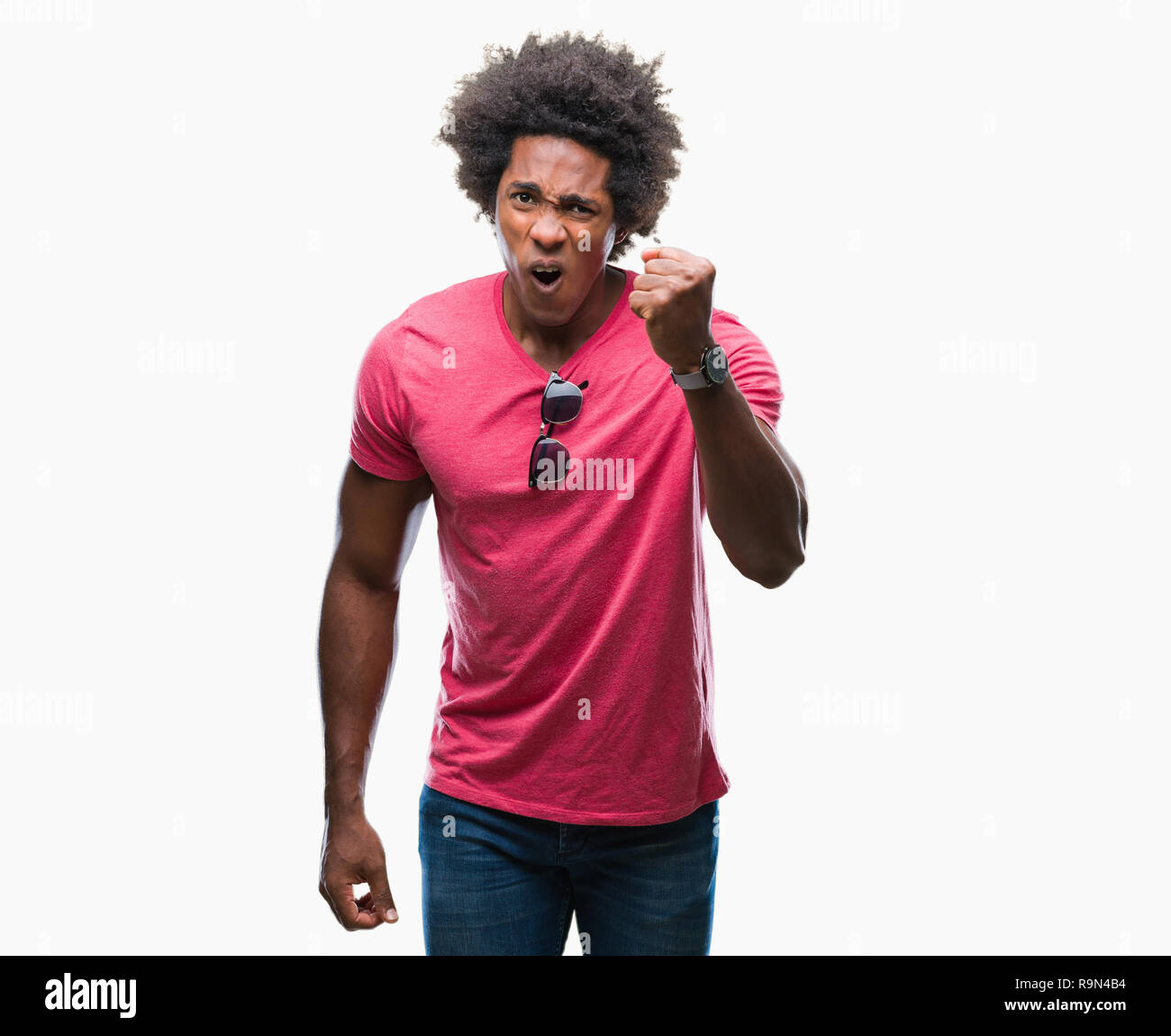 Afro american man over isolated background angry and mad raising fist ...