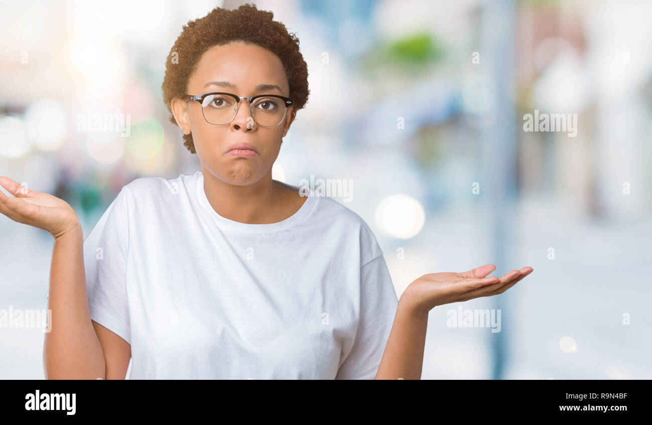Beautiful young african american woman wearing glasses over isolated ...