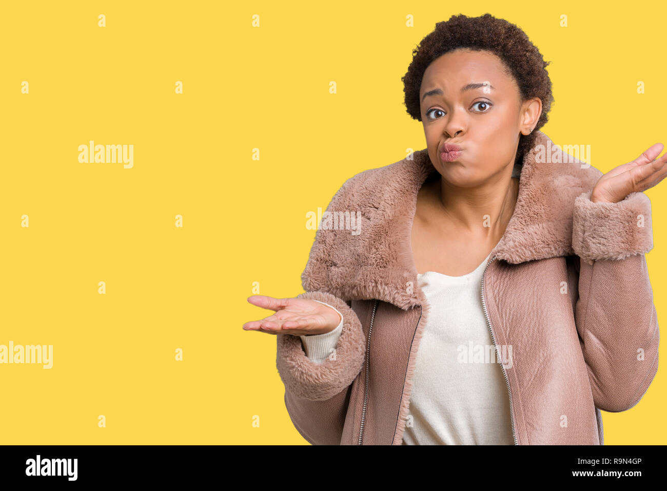 Young african american woman wearing winter coat over isolated ...