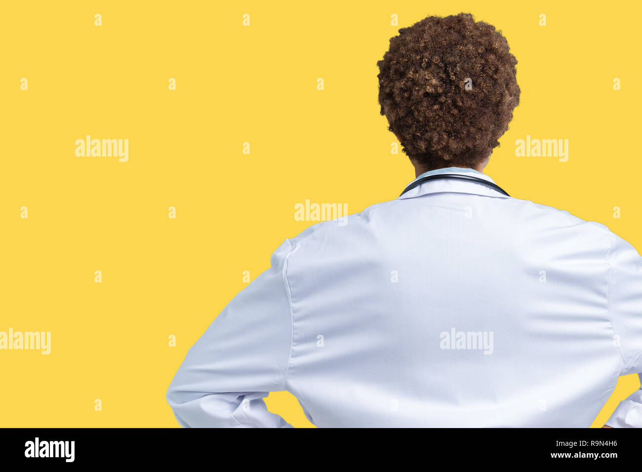 Young african american doctor woman wearing medical coat over isolated ...